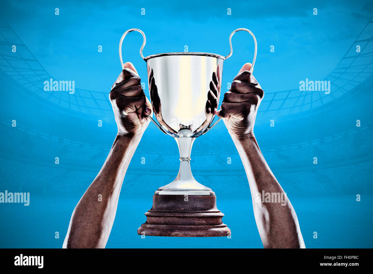 Composite image of cropped hand of athlete holding trophy Stock Photo ...