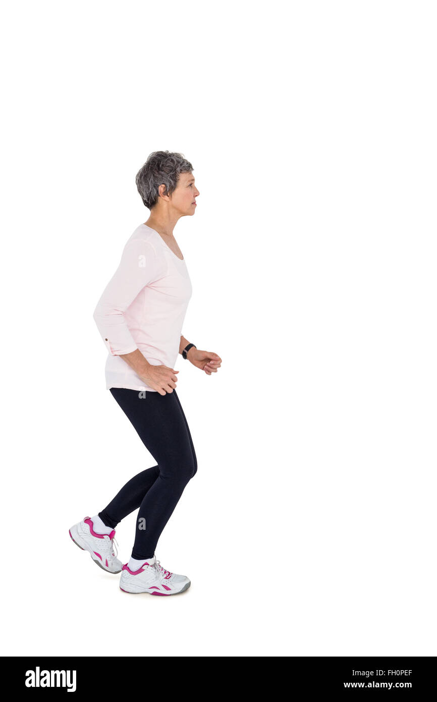 Side view of mature woman jogging Stock Photo - Alamy