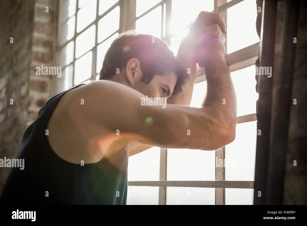Side view of a man looking outside Stock Photo - Alamy