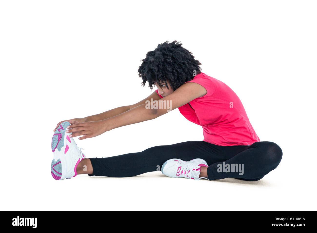 Young woman touching toes while exercising Stock Photo - Alamy