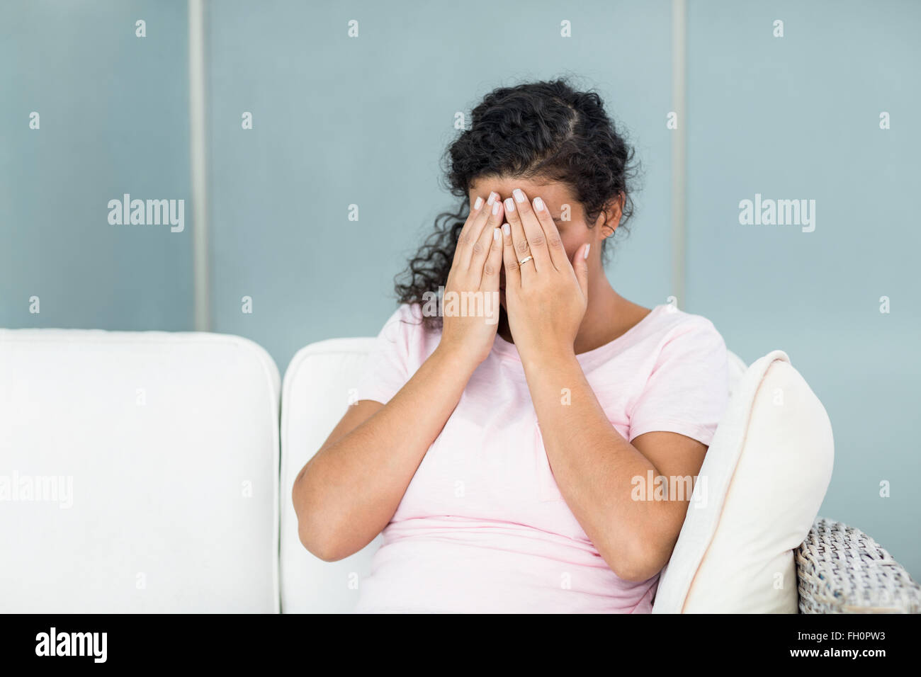 Upset woman with hands on face Stock Photo - Alamy