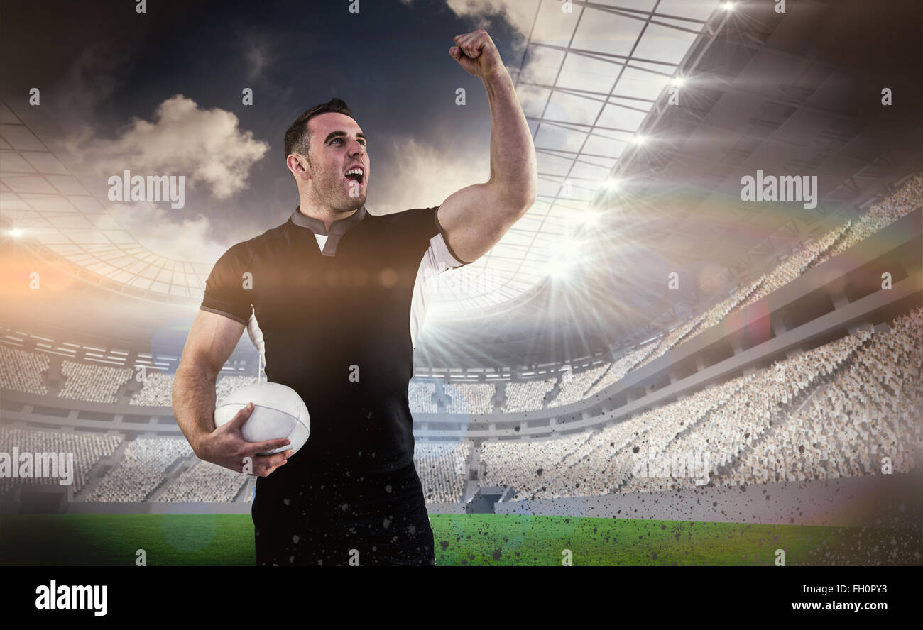 Composite image of rugby player cheering with the ball Stock Photo - Alamy