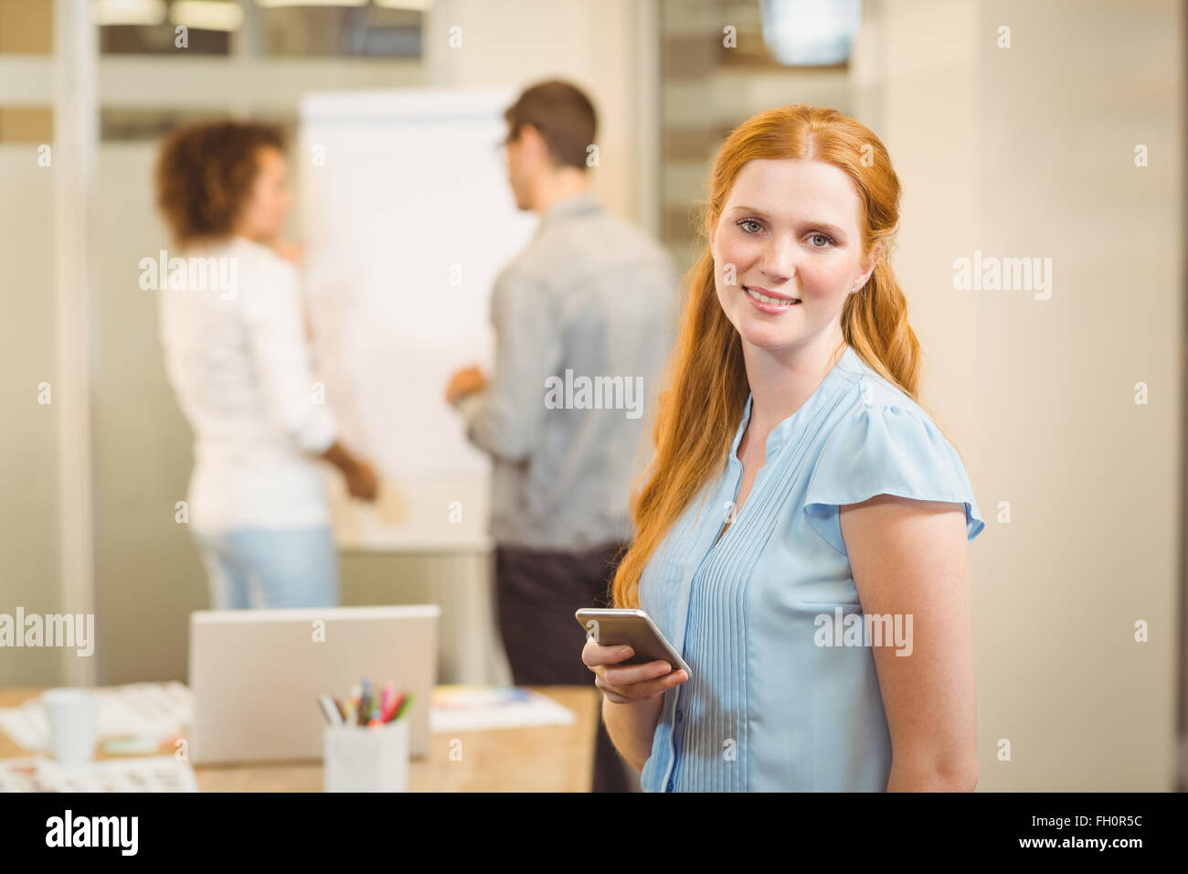 Confident businesswoman texting on phone Stock Photo - Alamy