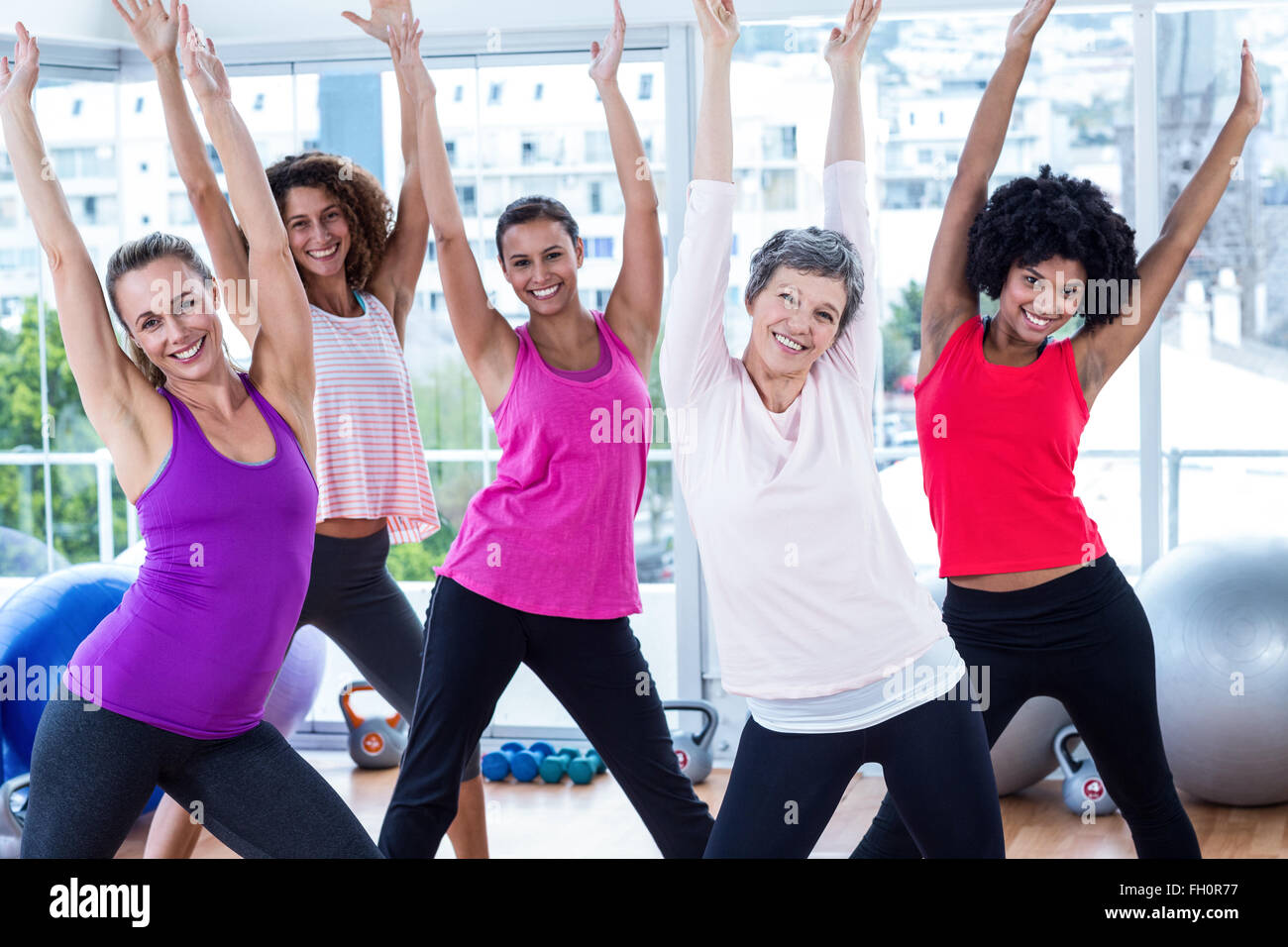 Portrait of happy women exercising with arms raised Stock Photo - Alamy