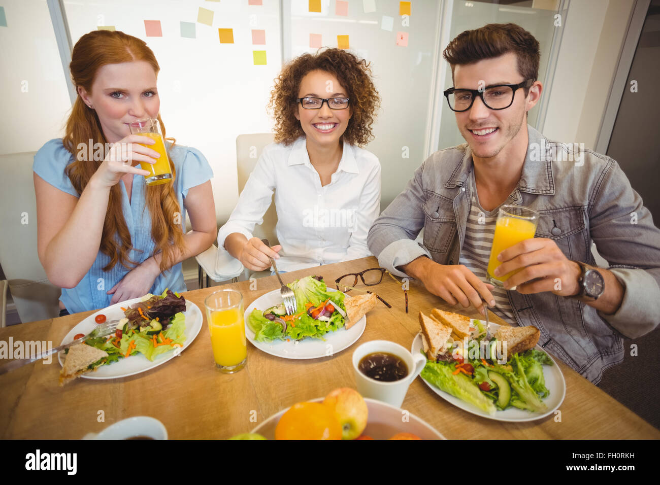 Smiling business people having breakfast Stock Photo - Alamy