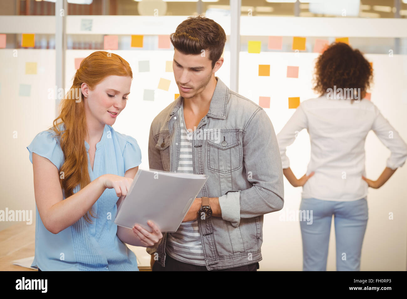 Business people looking at document Stock Photo - Alamy