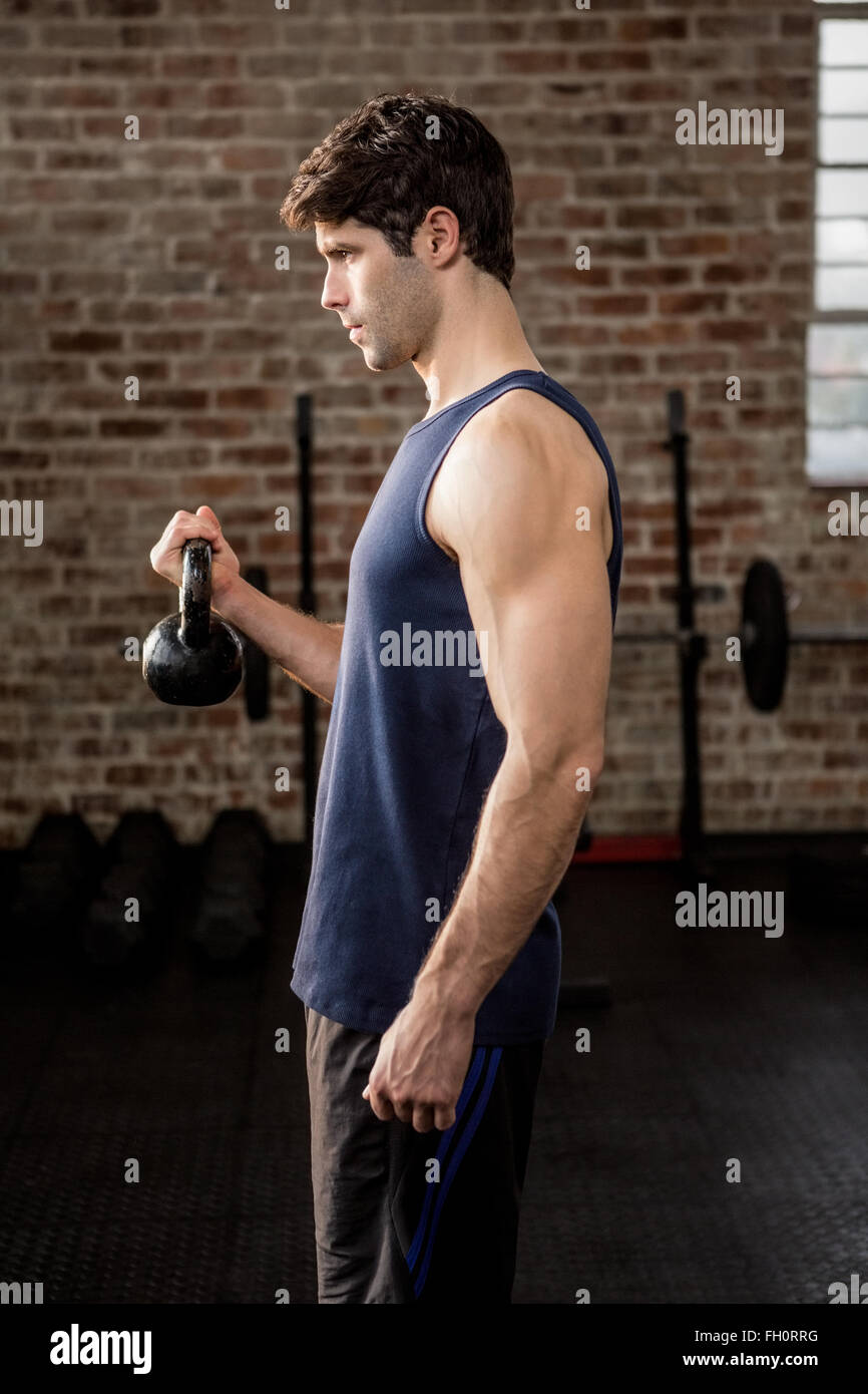 Side view of man lifting kettlebell Stock Photo - Alamy