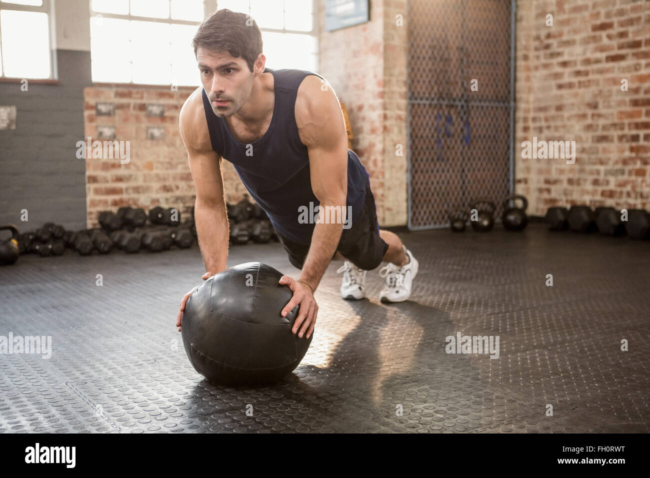 Man doing push ups on medicine ball Stock Photo - Alamy