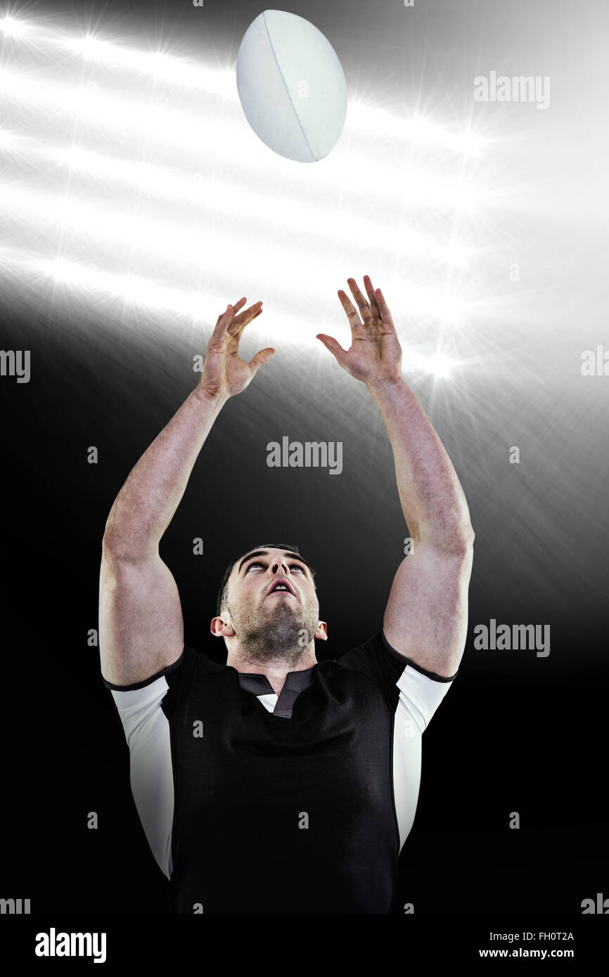 Composite image of rugby player catching the ball Stock Photo - Alamy