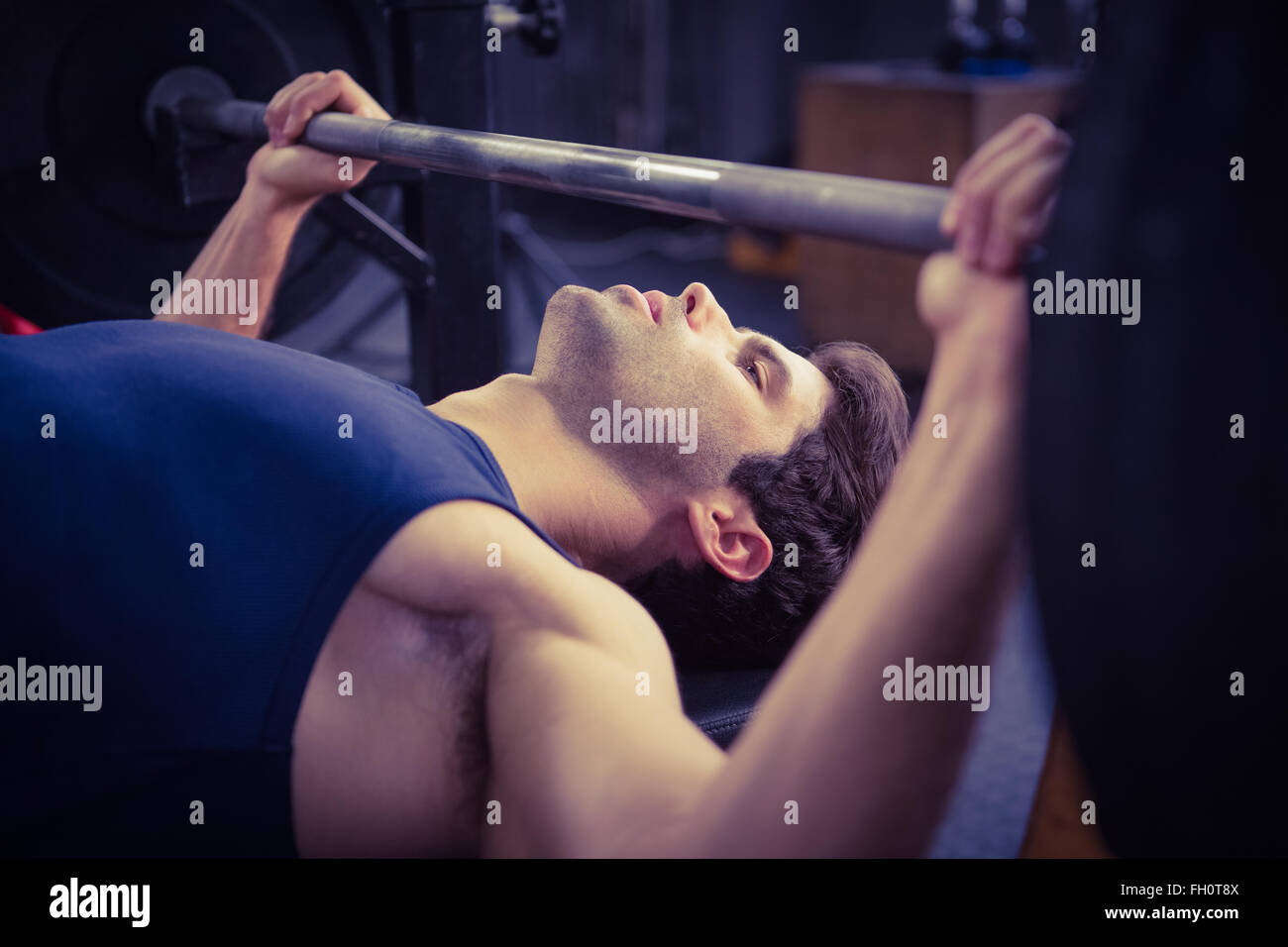 Side view of a man holding barbell Stock Photo - Alamy