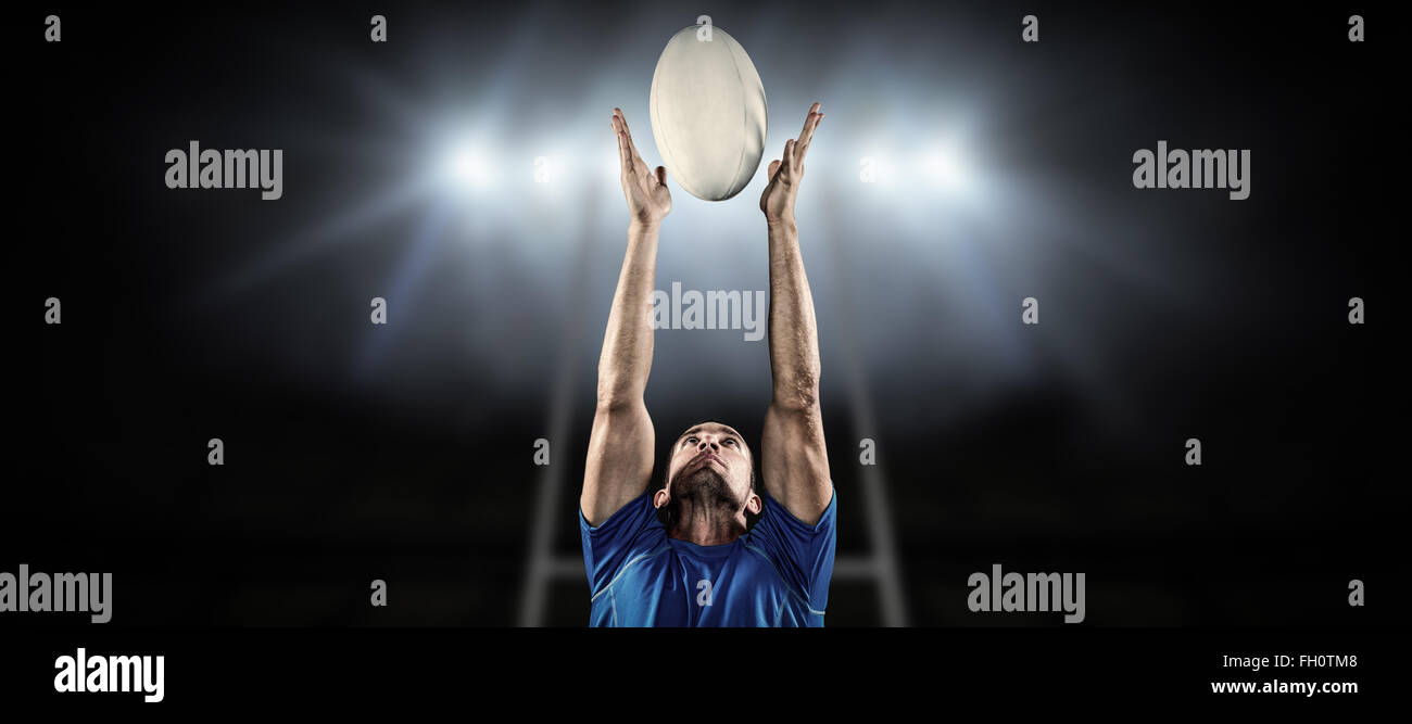 Composite image of rugby player catching ball Stock Photo - Alamy