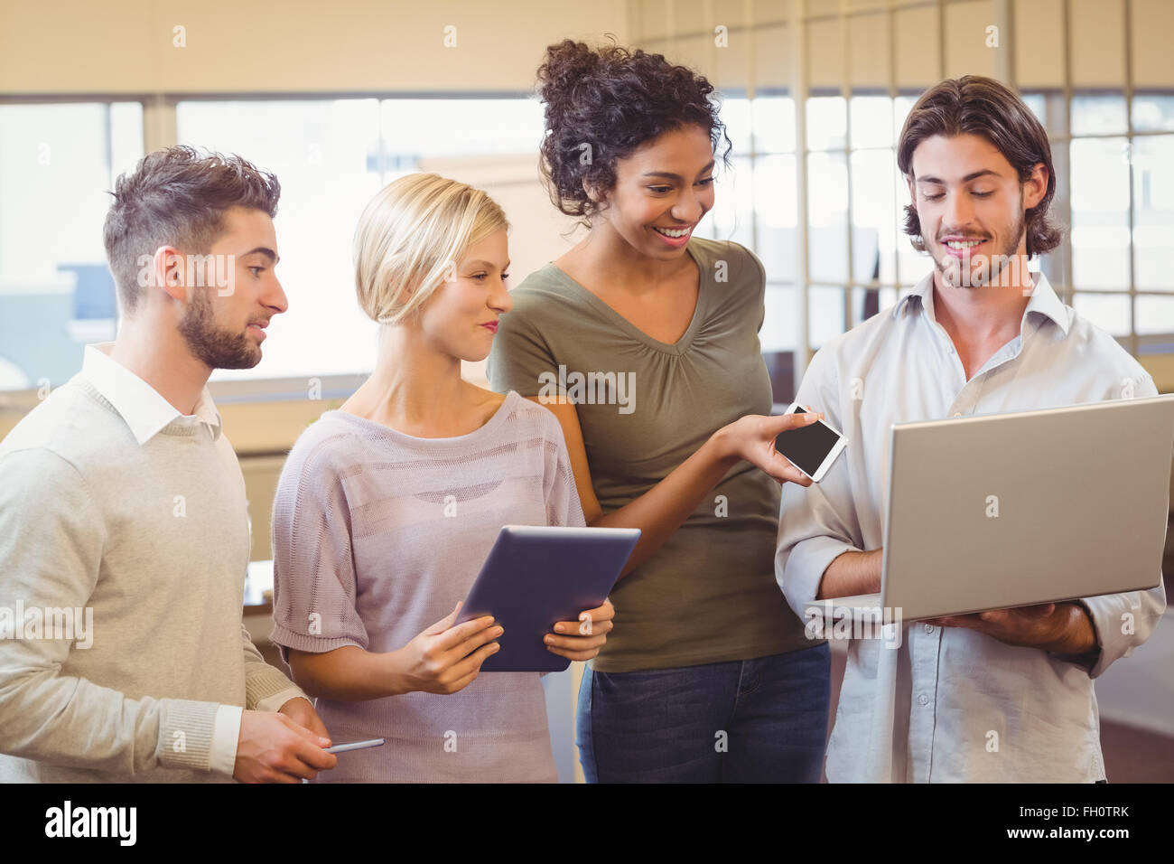 Business team using laptop in office Stock Photo - Alamy