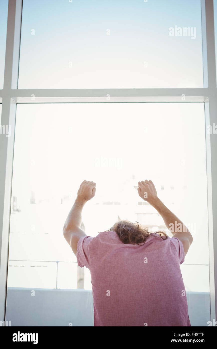 Rear view of man leaning against window glass Stock Photo - Alamy
