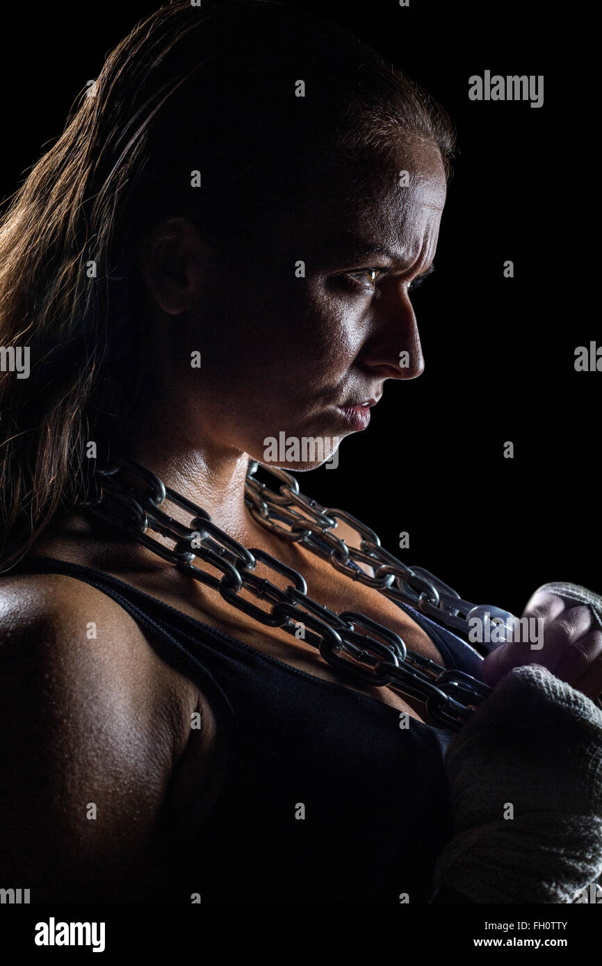 Side view of female angry athlete holding chain Stock Photo - Alamy