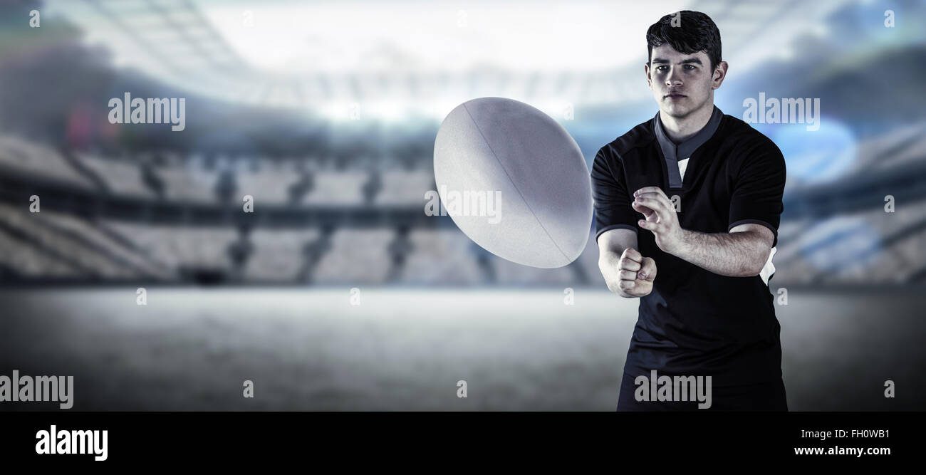 Composite image of rugby player throwing a rugby ball Stock Photo - Alamy