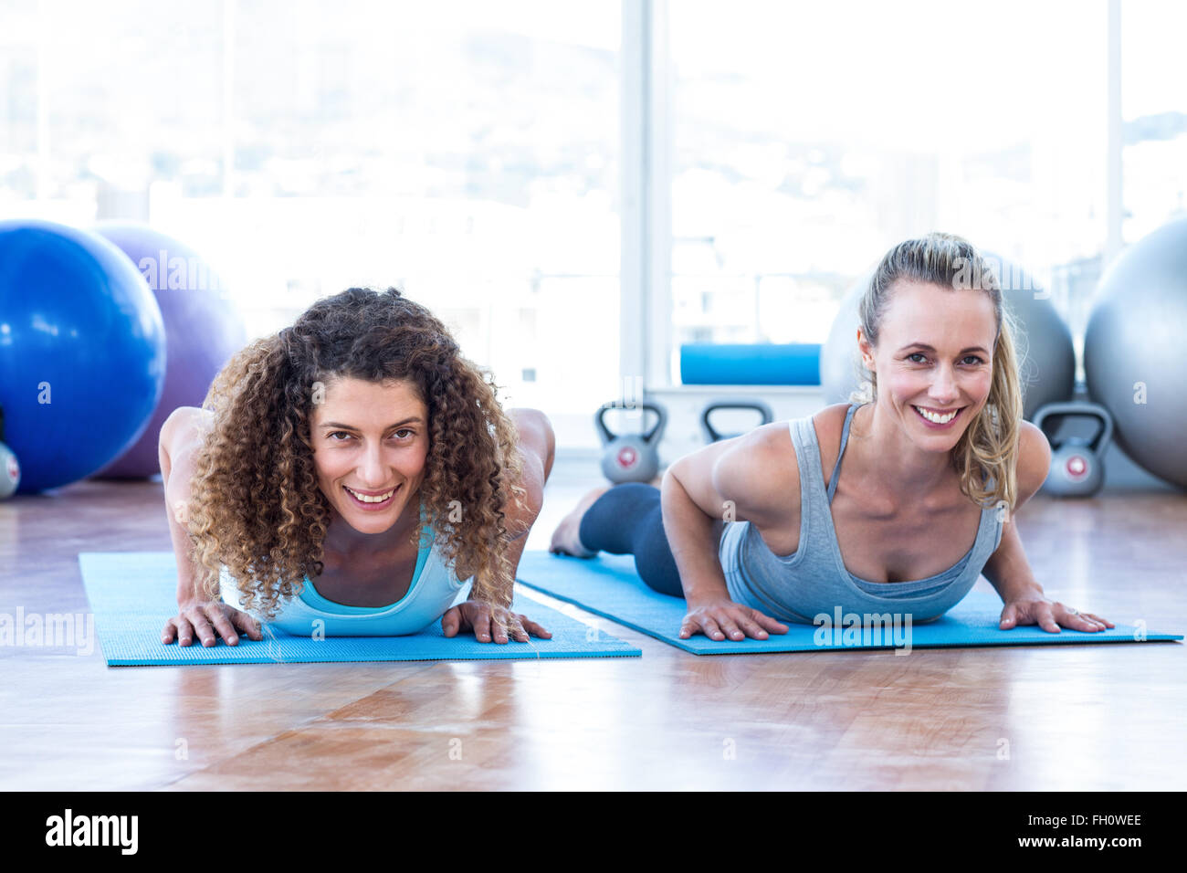 Portrait of women doing modified cobra pose Stock Photo - Alamy