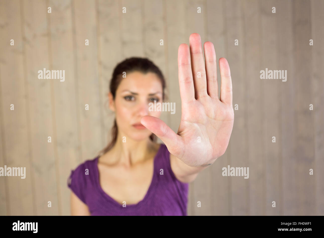 Portrait of serious woman showing stop sign Stock Photo - Alamy