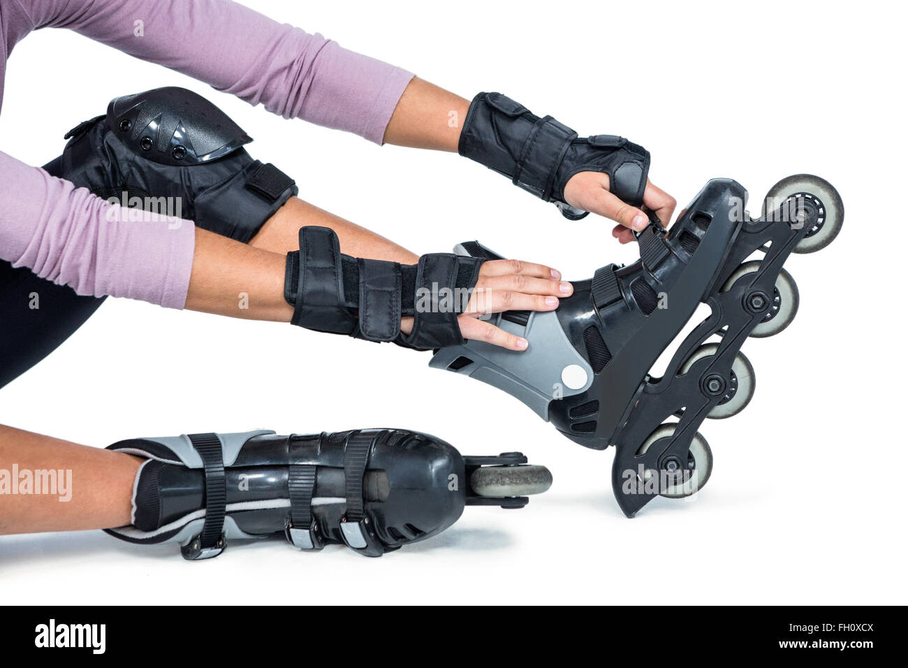 Low section of woman wearing inline skates Stock Photo - Alamy