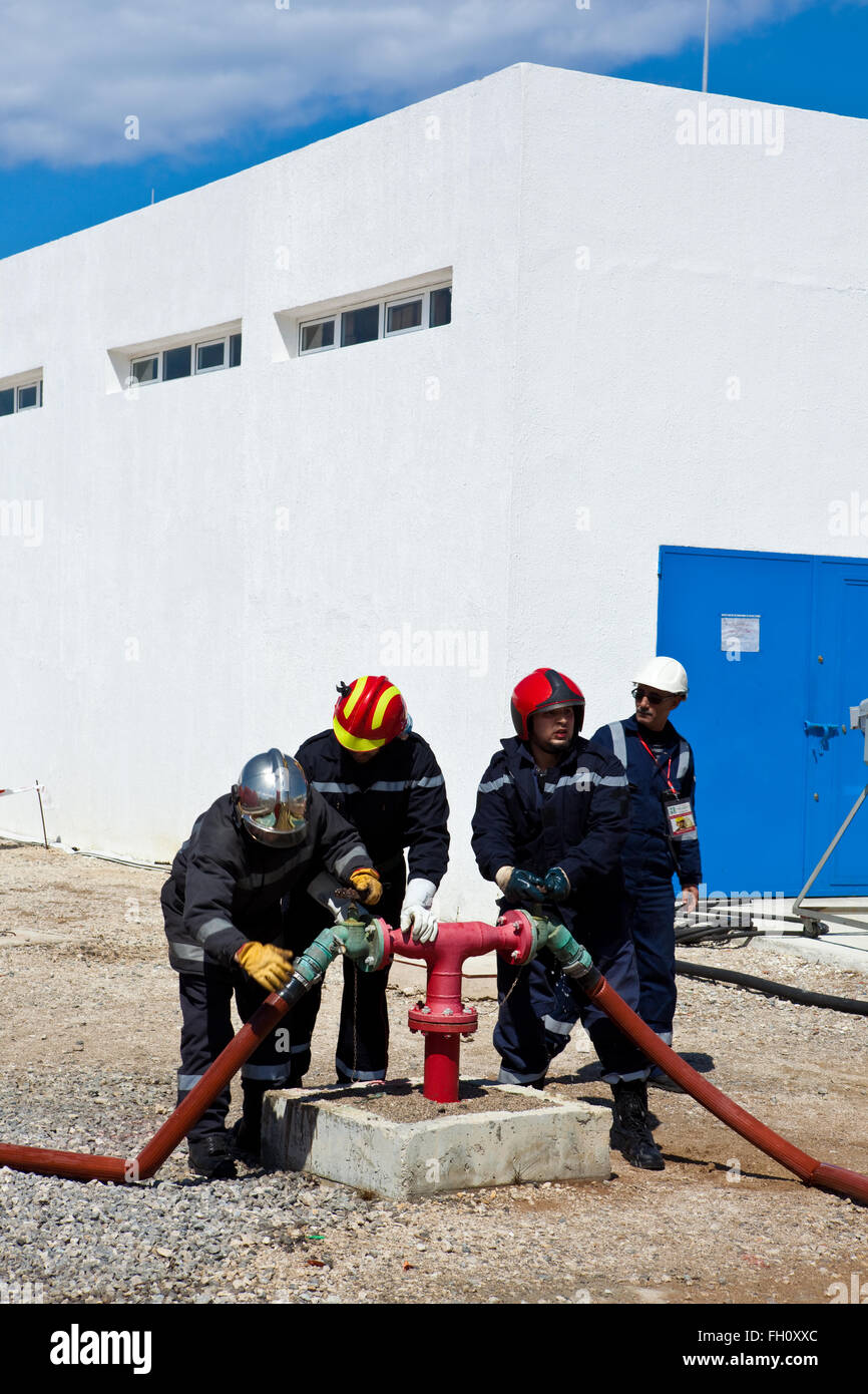 Firefighters applying foam to oil storage tank Stock Photo - Alamy