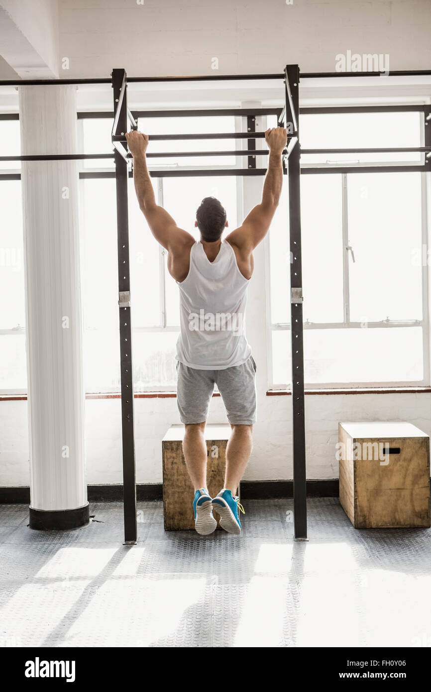 Rear view of man doing pull ups Stock Photo - Alamy