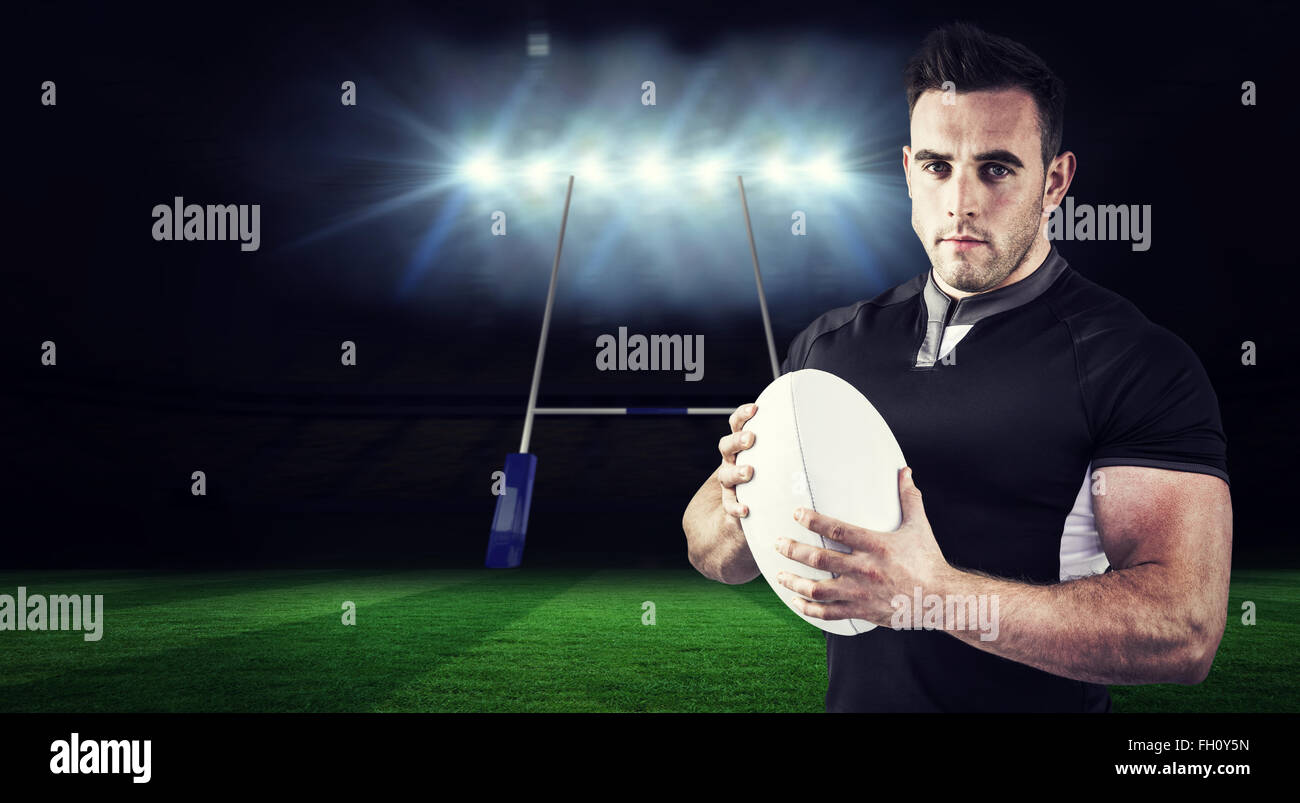 Composite image of tough rugby player looking at camera Stock Photo - Alamy