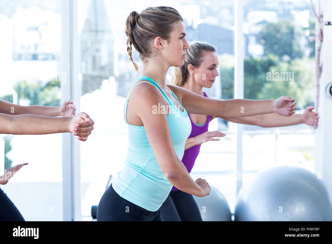 Side view of women with left hand stretched Stock Photo - Alamy