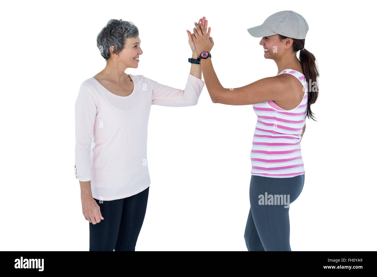 Cheerful women high fiving Stock Photo - Alamy