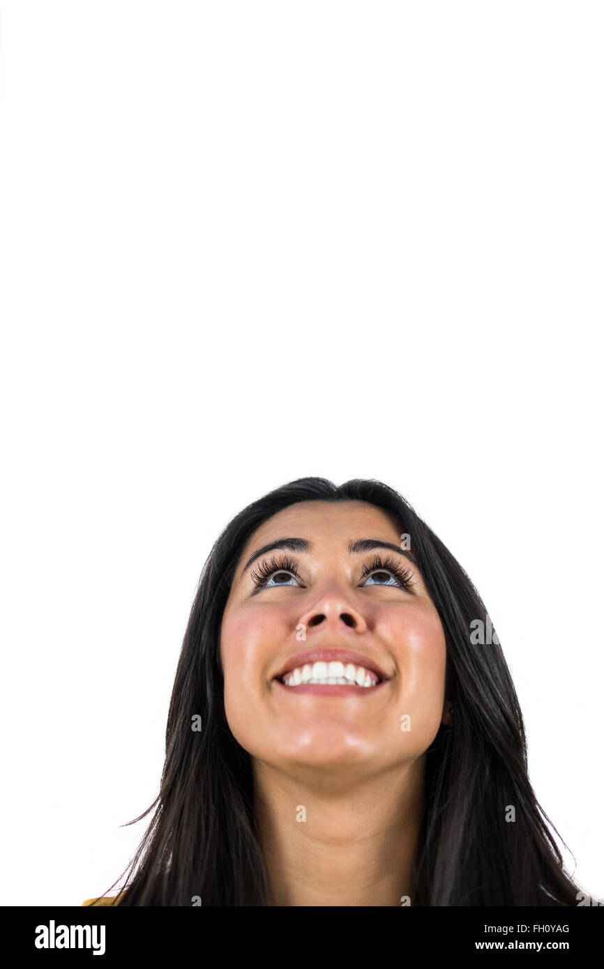 Cute woman looking above her Stock Photo - Alamy