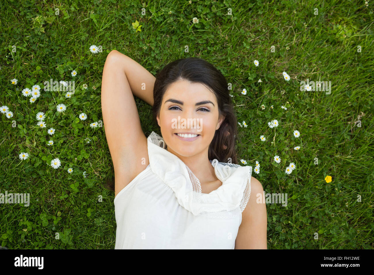 Portrait of woman relaxing with hand behind head Stock Photo - Alamy