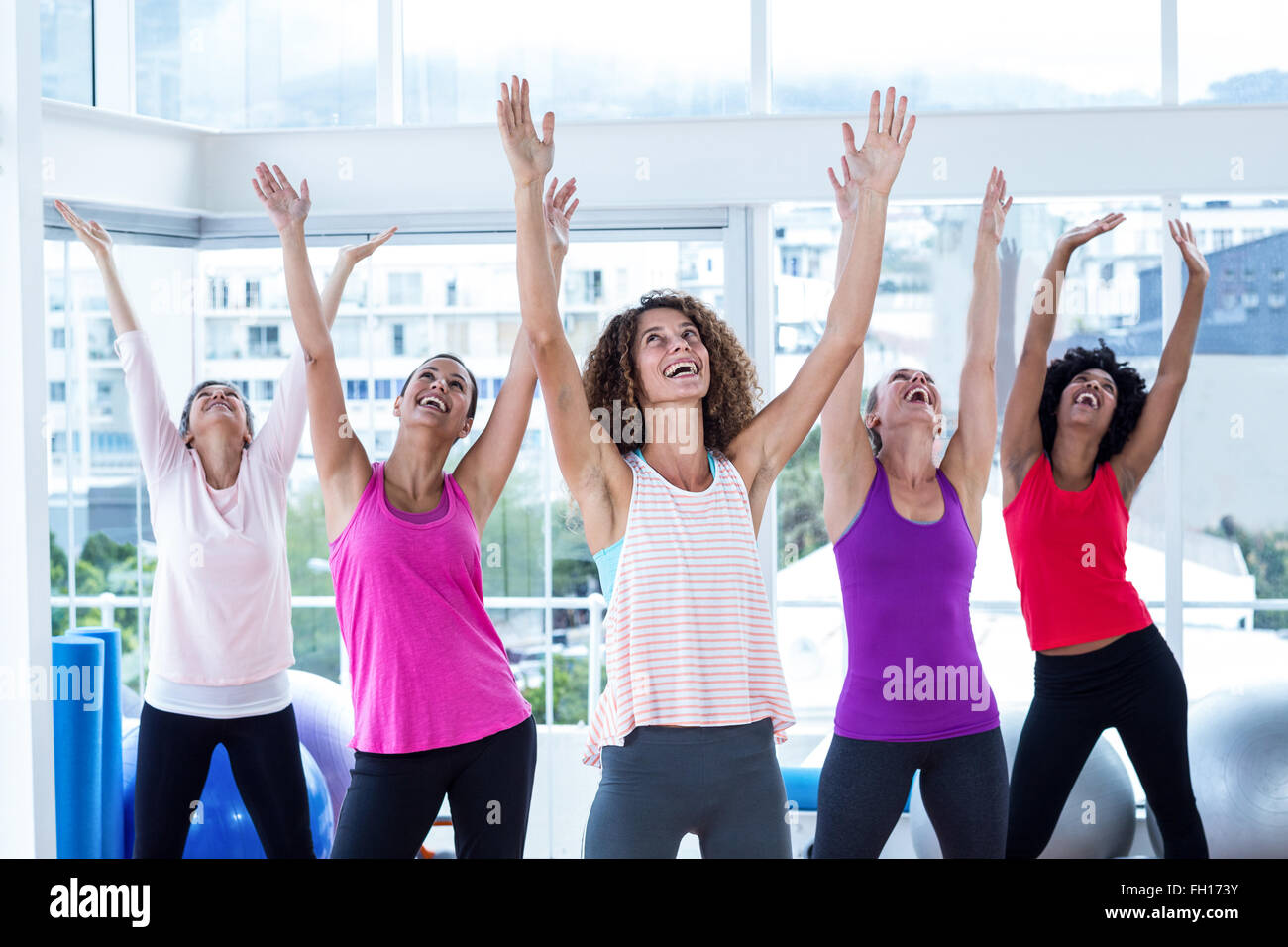 Portrait of happy women exercising with arms raised Stock Photo - Alamy