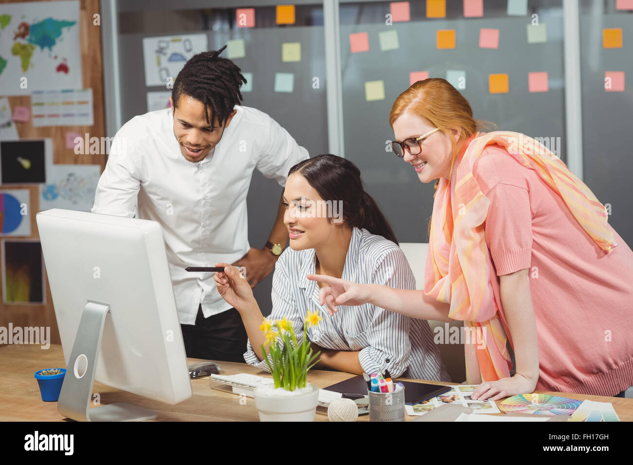Smiling business people using computer in office Stock Photo - Alamy