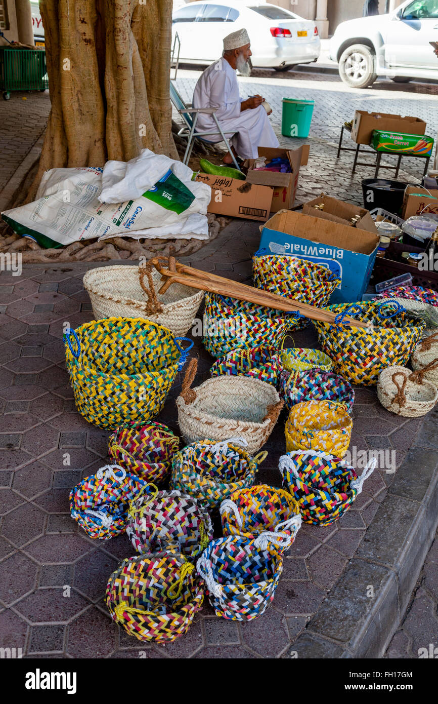 An Elderly Man Selling Colourful Baskets In The Street, The Nizwa Souk ...