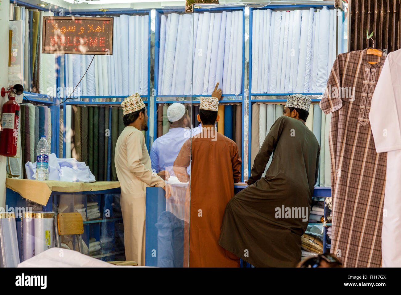 Young Omani Men Choosing Fabrics At A Shop In The Nizwa Souk, Nizwa, Ad ...