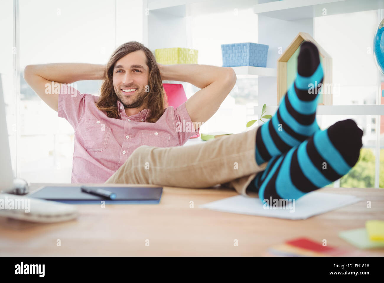 Hipster realaxing with legs on desk Stock Photo - Alamy