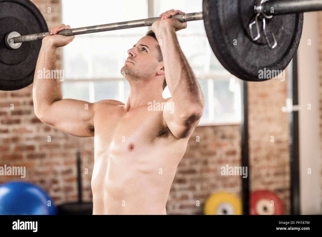 Muscular man doing weightlifting Stock Photo - Alamy