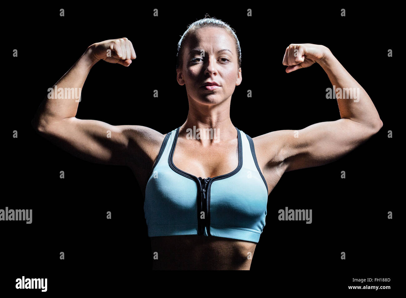 Thoughtful athlete flexing muscles Stock Photo - Alamy