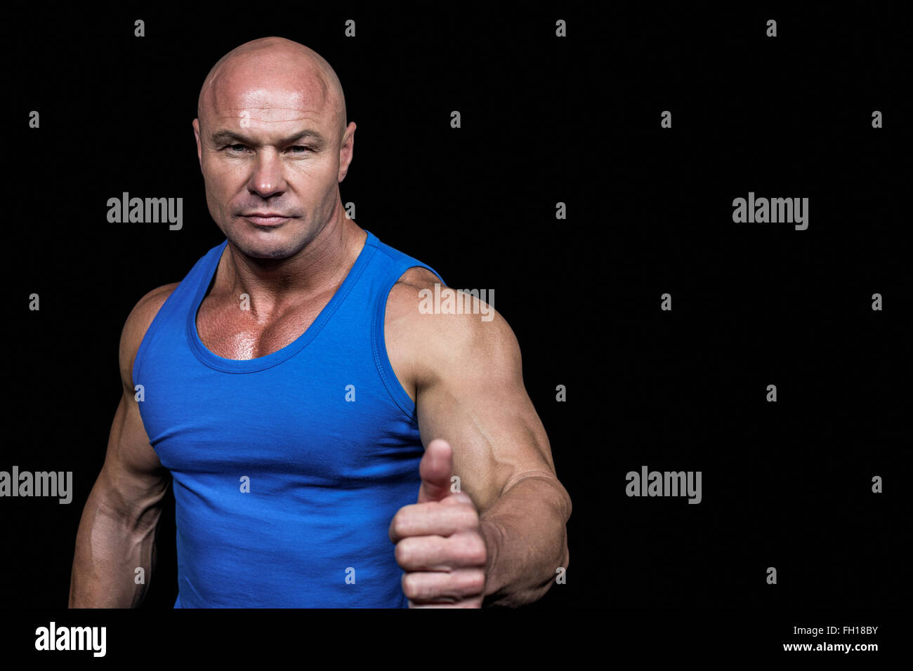 Portrait of confident muscular man showing thumbs up Stock Photo - Alamy