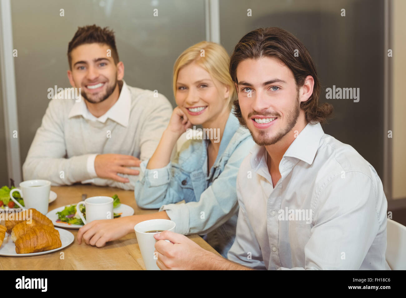 Smiling business people having snacks Stock Photo - Alamy