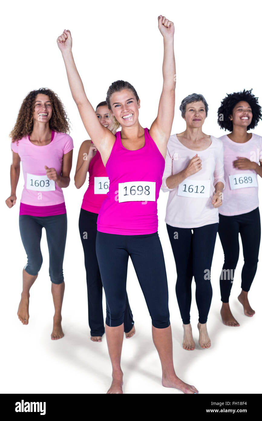 Full length portrait of smiling winner athlete with arms raised and ...