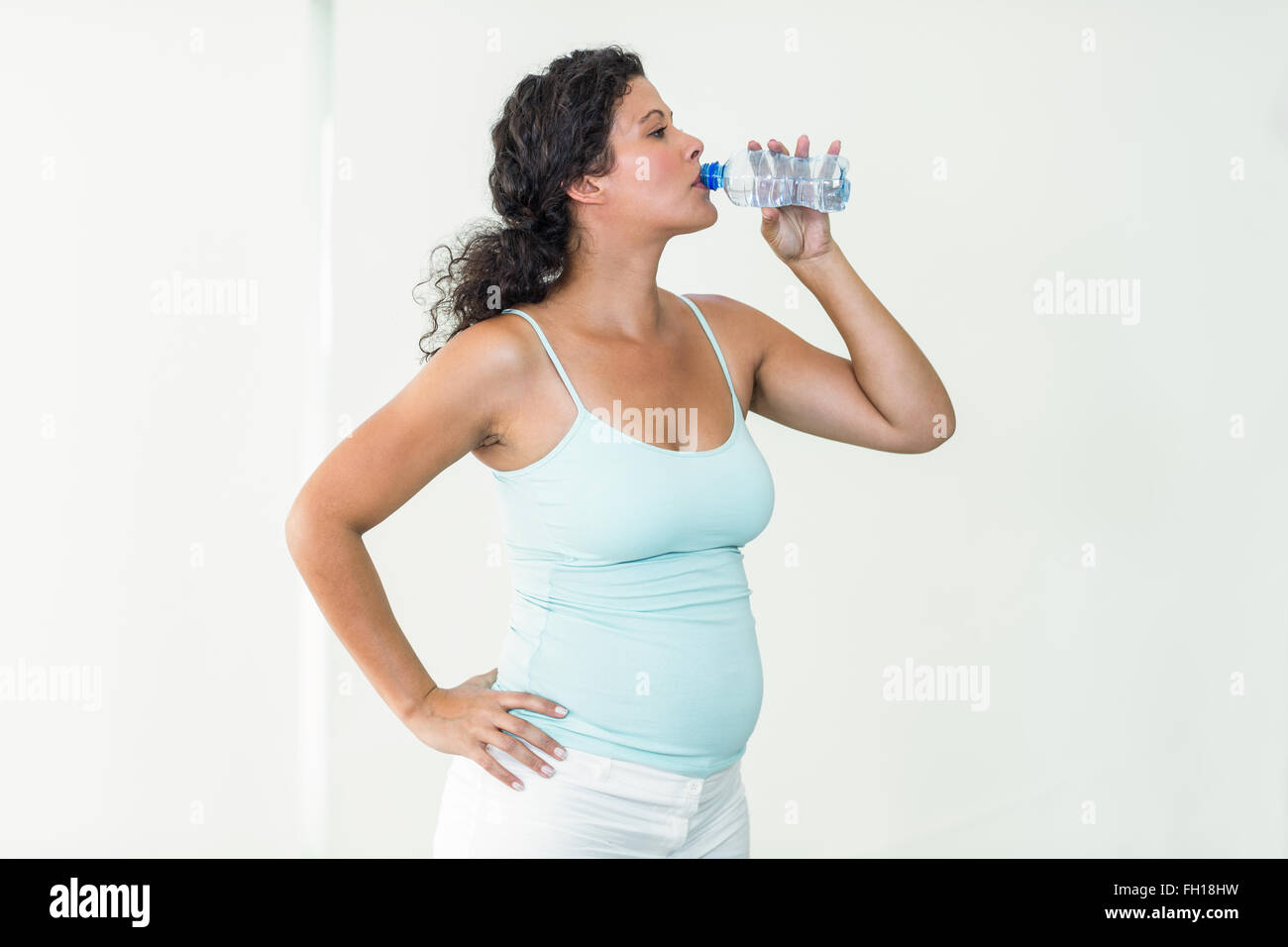 Pregnant woman drinking water Stock Photo - Alamy