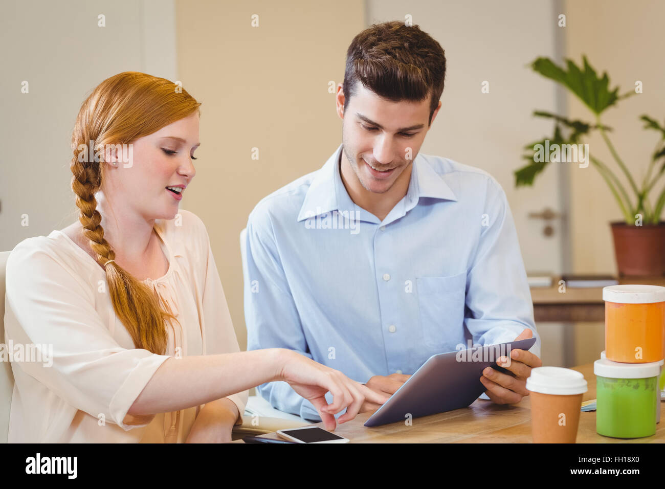 Business people using digital tablet at desk Stock Photo - Alamy