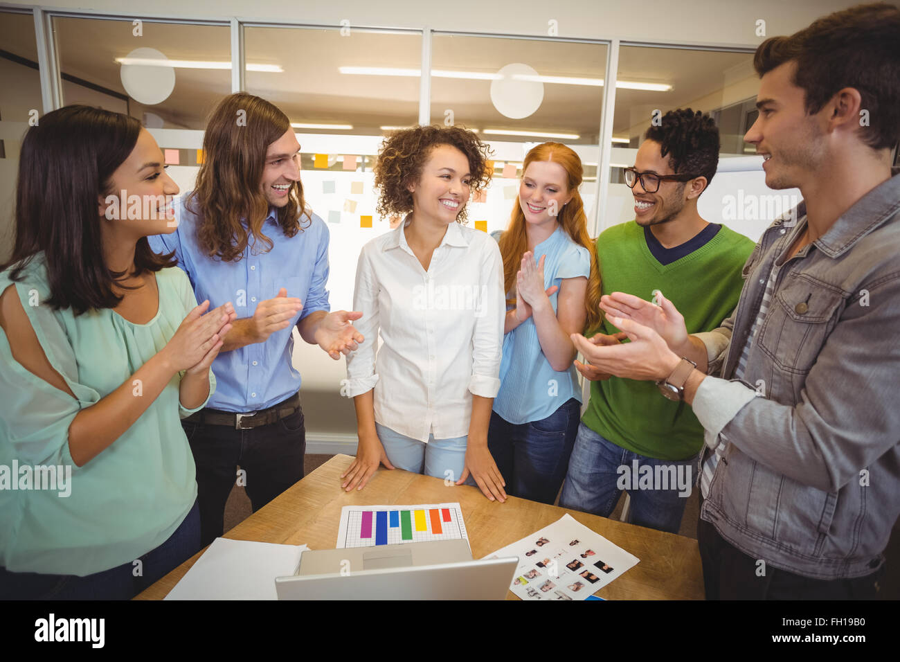 Happy colleagues appreciating businesswoman Stock Photo - Alamy