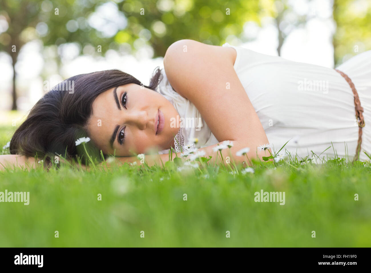 Portrait of beautiful woman relaxing on grassland Stock Photo - Alamy