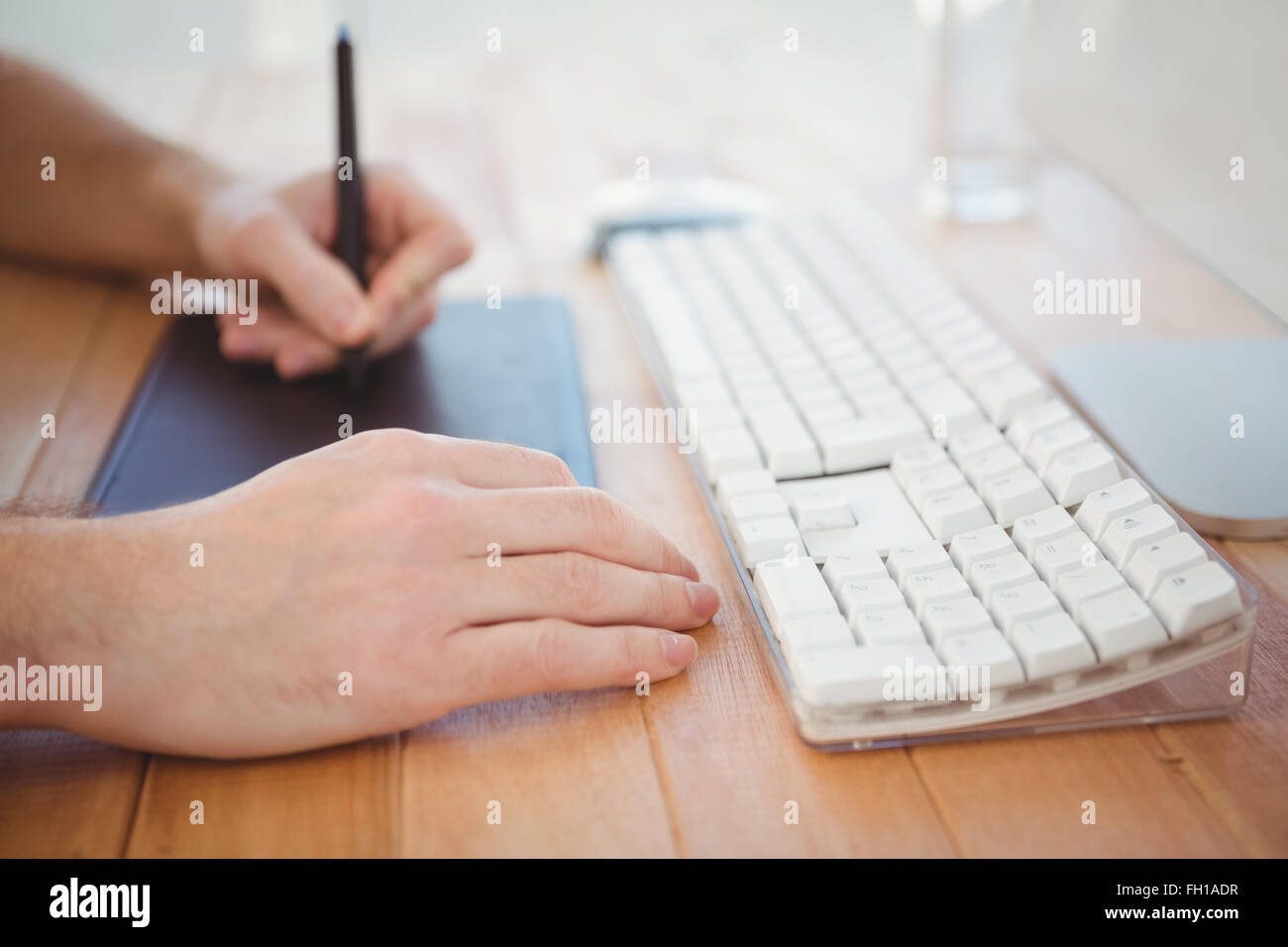 Man using graphics tablet at computer desk Stock Photo - Alamy