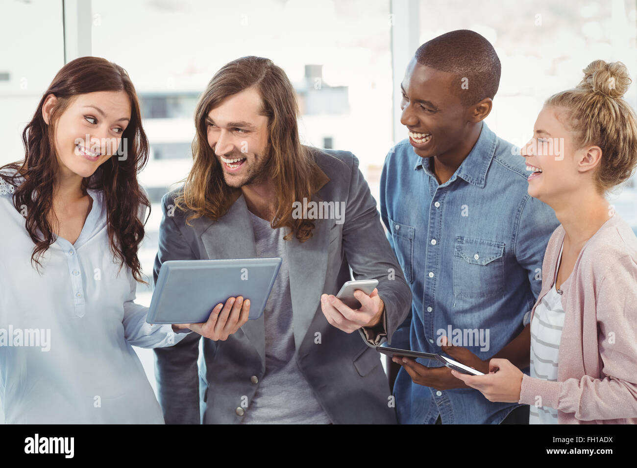Happy business team using technology Stock Photo - Alamy