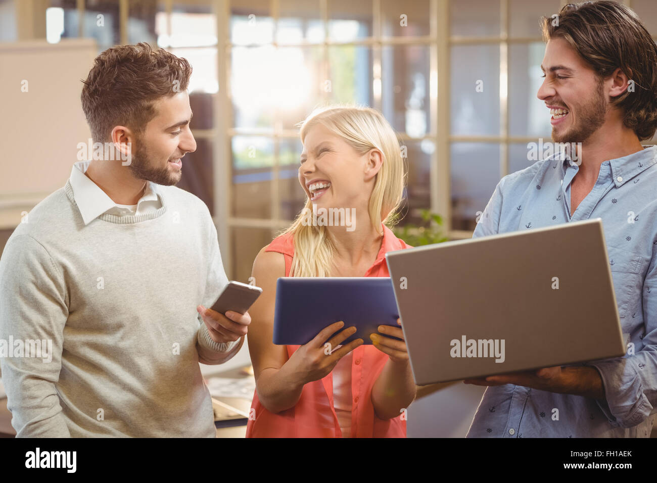 Happy business people using technologies Stock Photo - Alamy