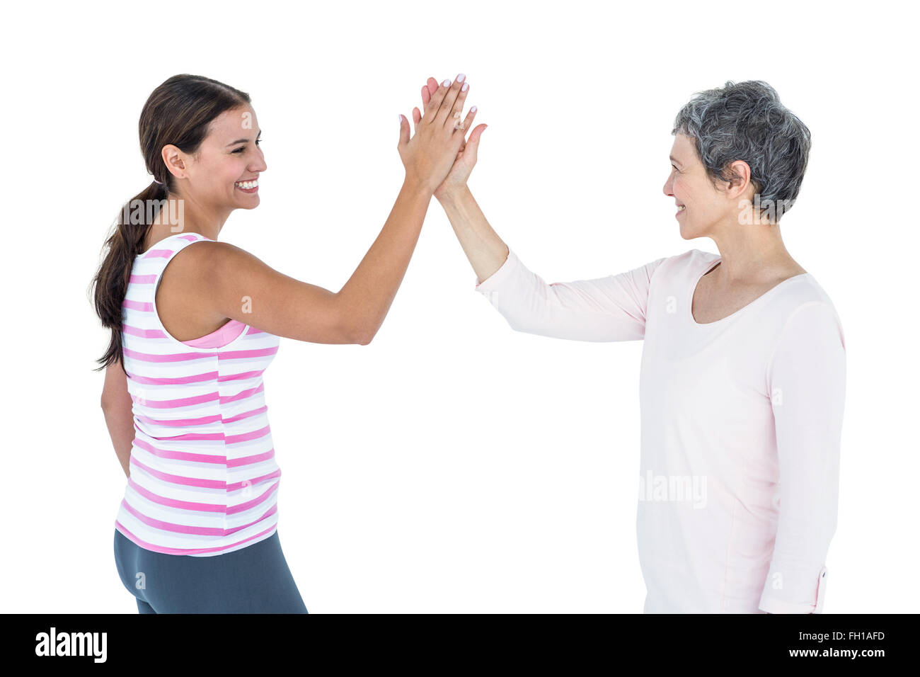 Happy women high fiving Stock Photo - Alamy