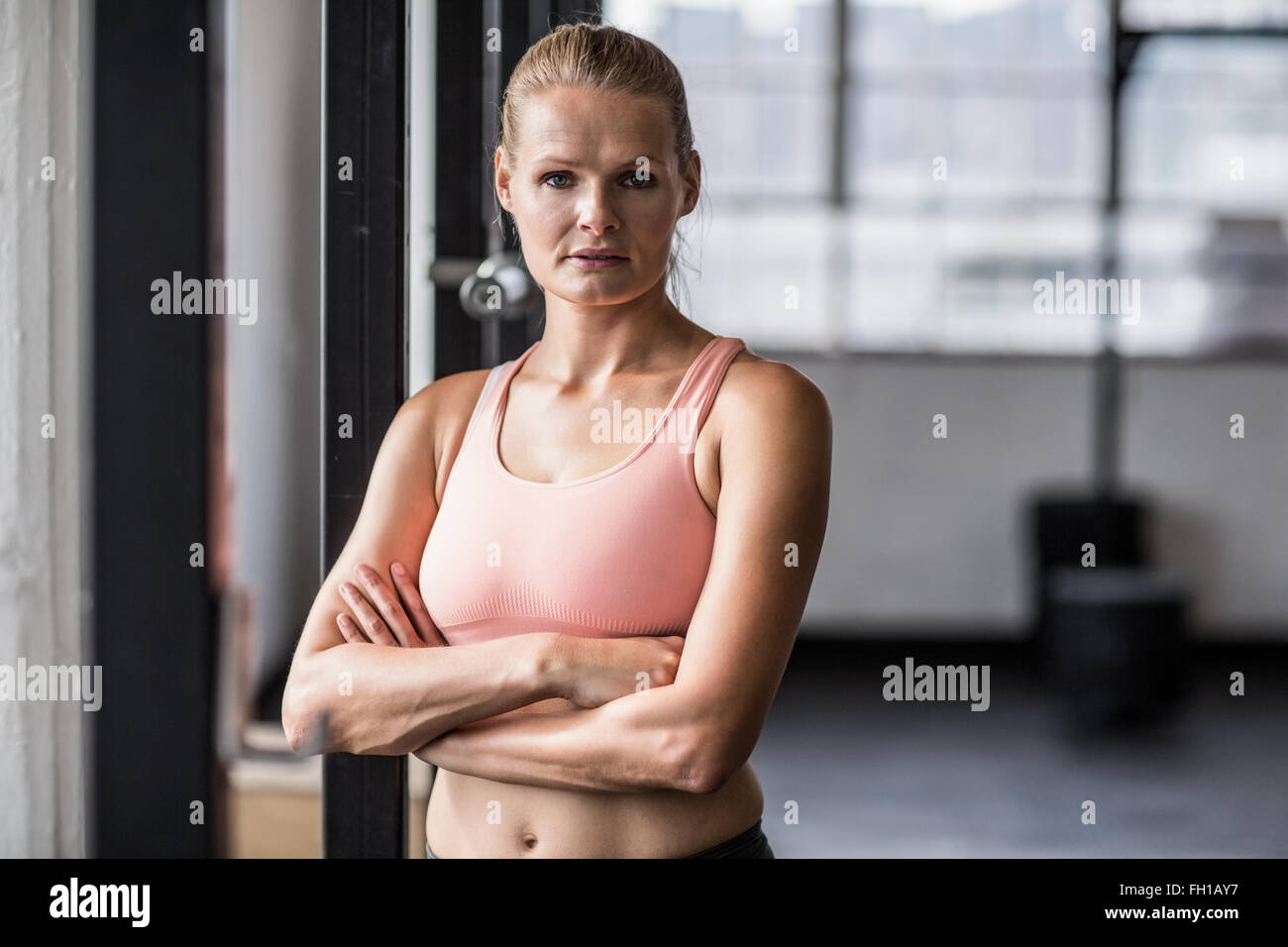 Muscular serious woman with hands on hips Stock Photo - Alamy