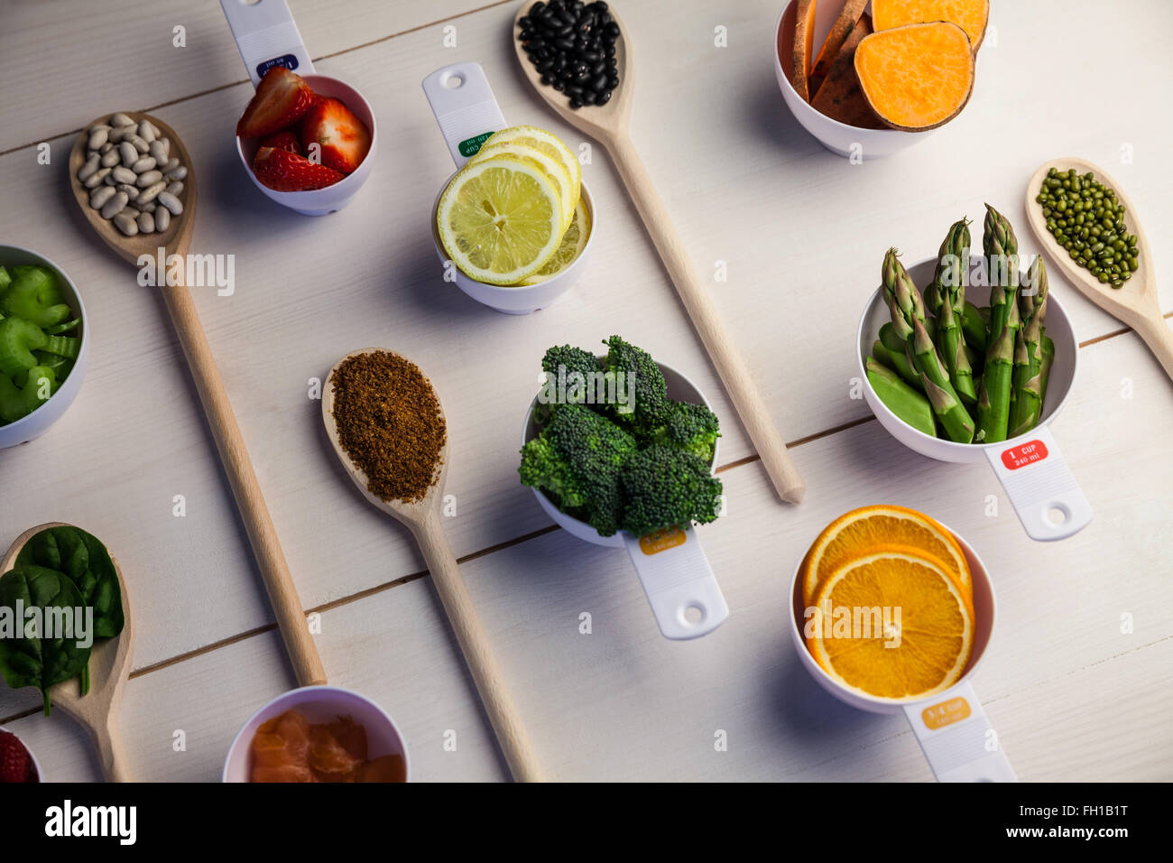 Portion cups and spoons of healthy ingredients Stock Photo - Alamy