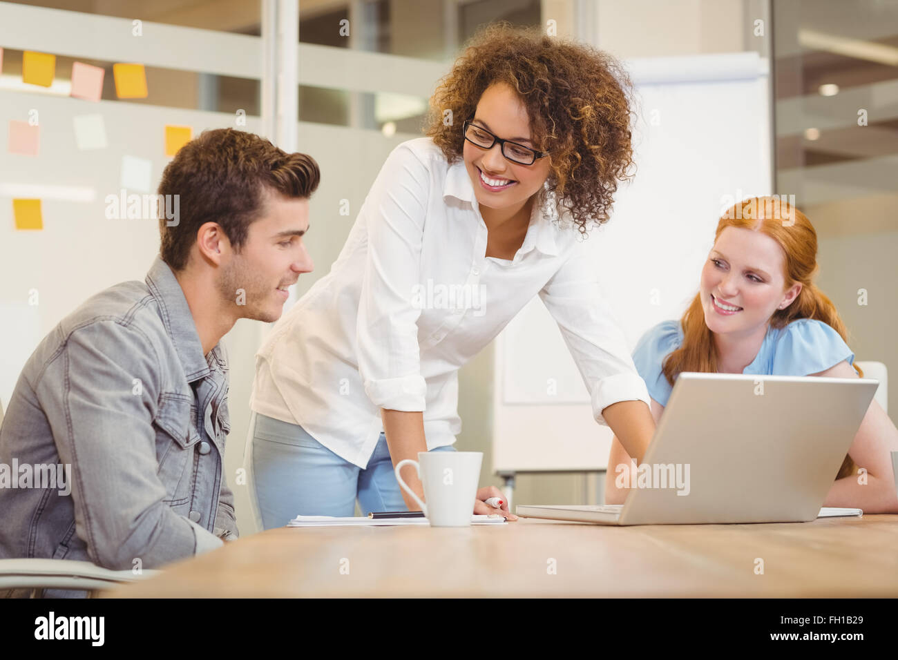 Female colleagues looking at businessman Stock Photo - Alamy